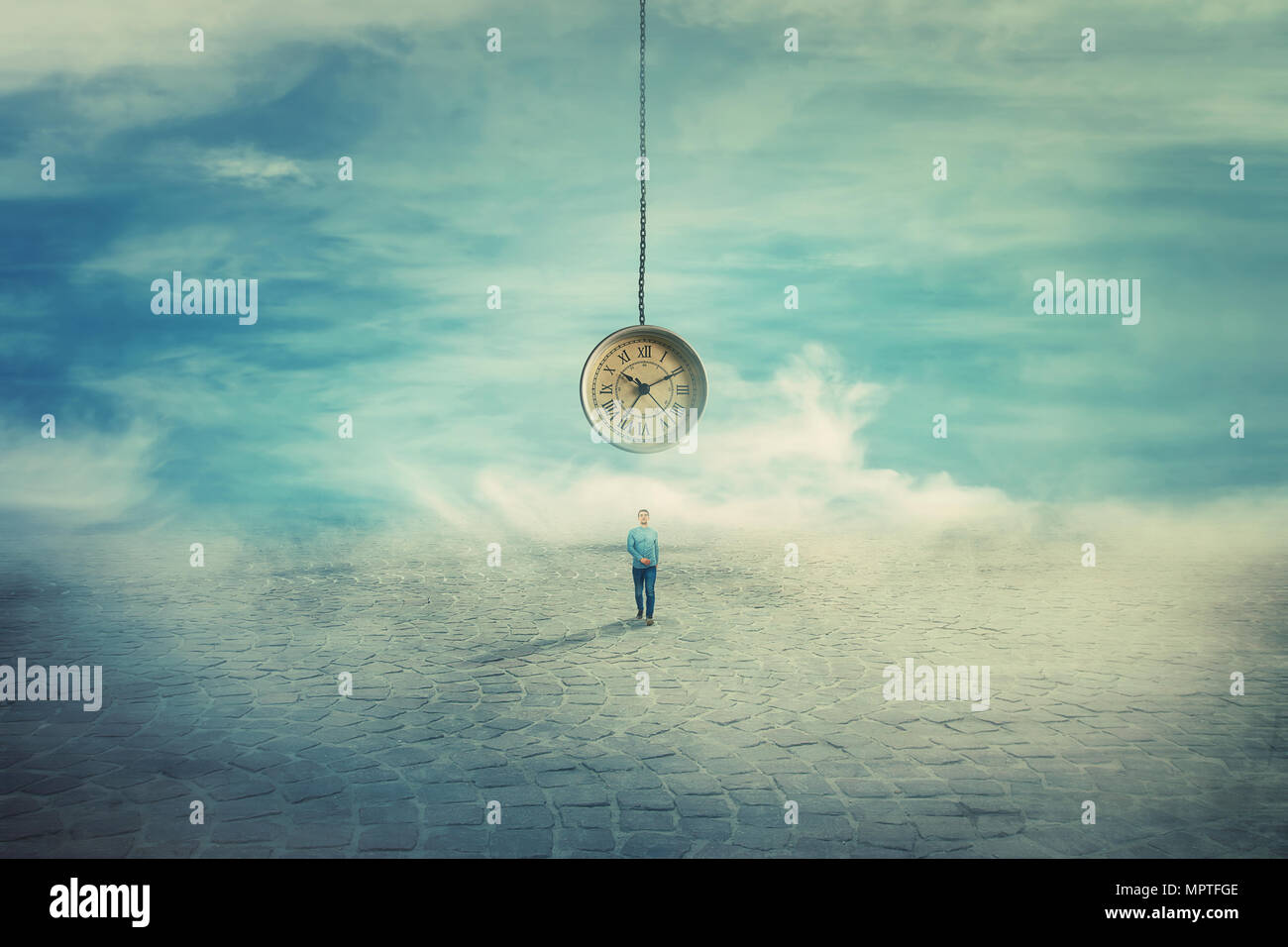 Surreal view as a man walking on a pavement road and a suspended clock ... Surreal view as a man walking on a pavement road and a suspended clock ...