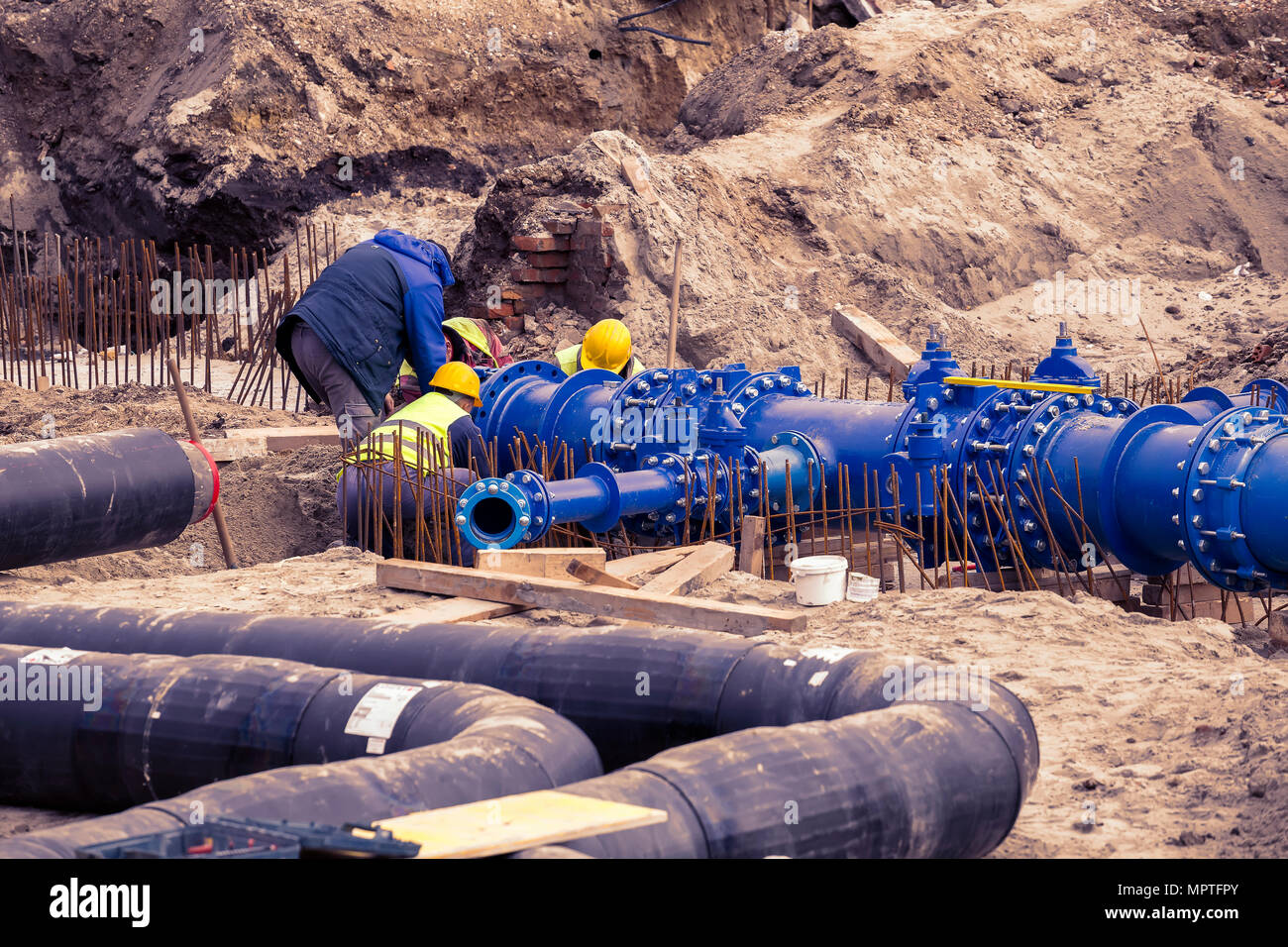 Construction workers laid water system pipeline at construction site ...