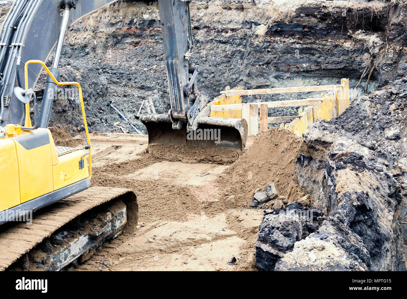 Excavator working with earth and sand in sandpit during rebuilding the ...