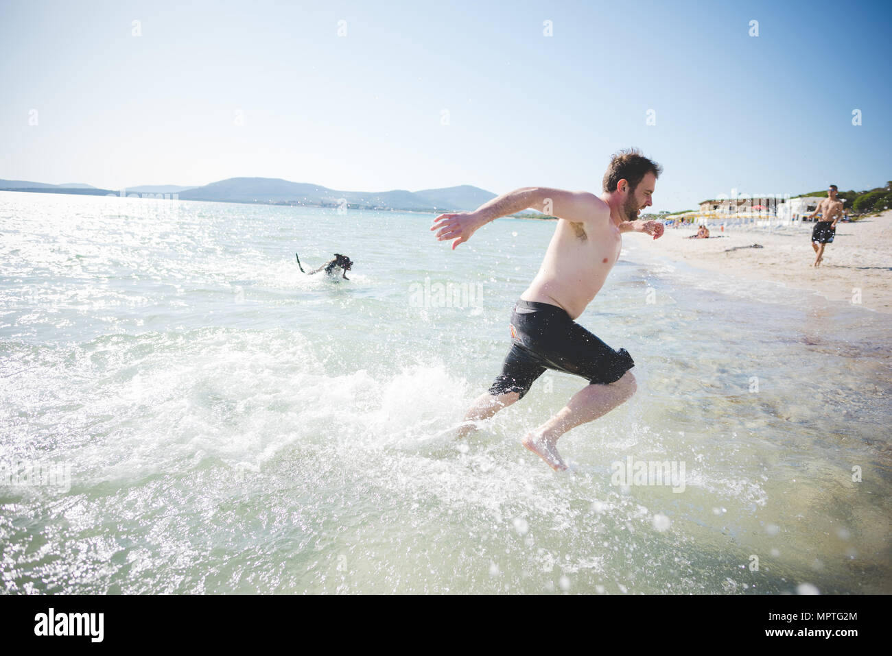 Group of friends millennials wearing swimsuits splashing around having ...