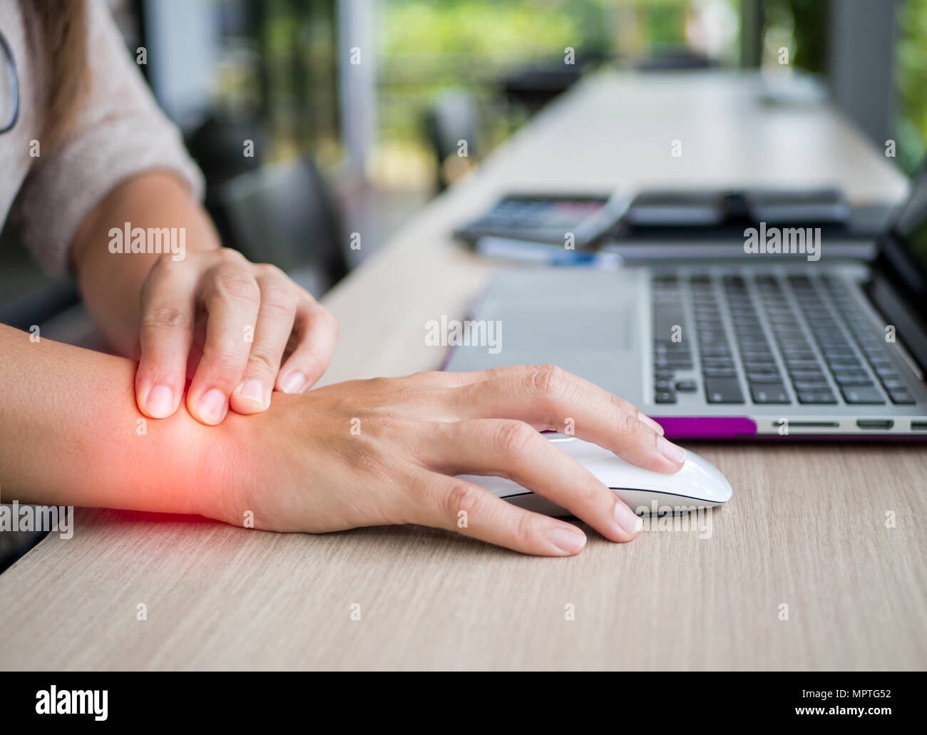 Closeup woman holding her wrist pain from using computer. Office ...
