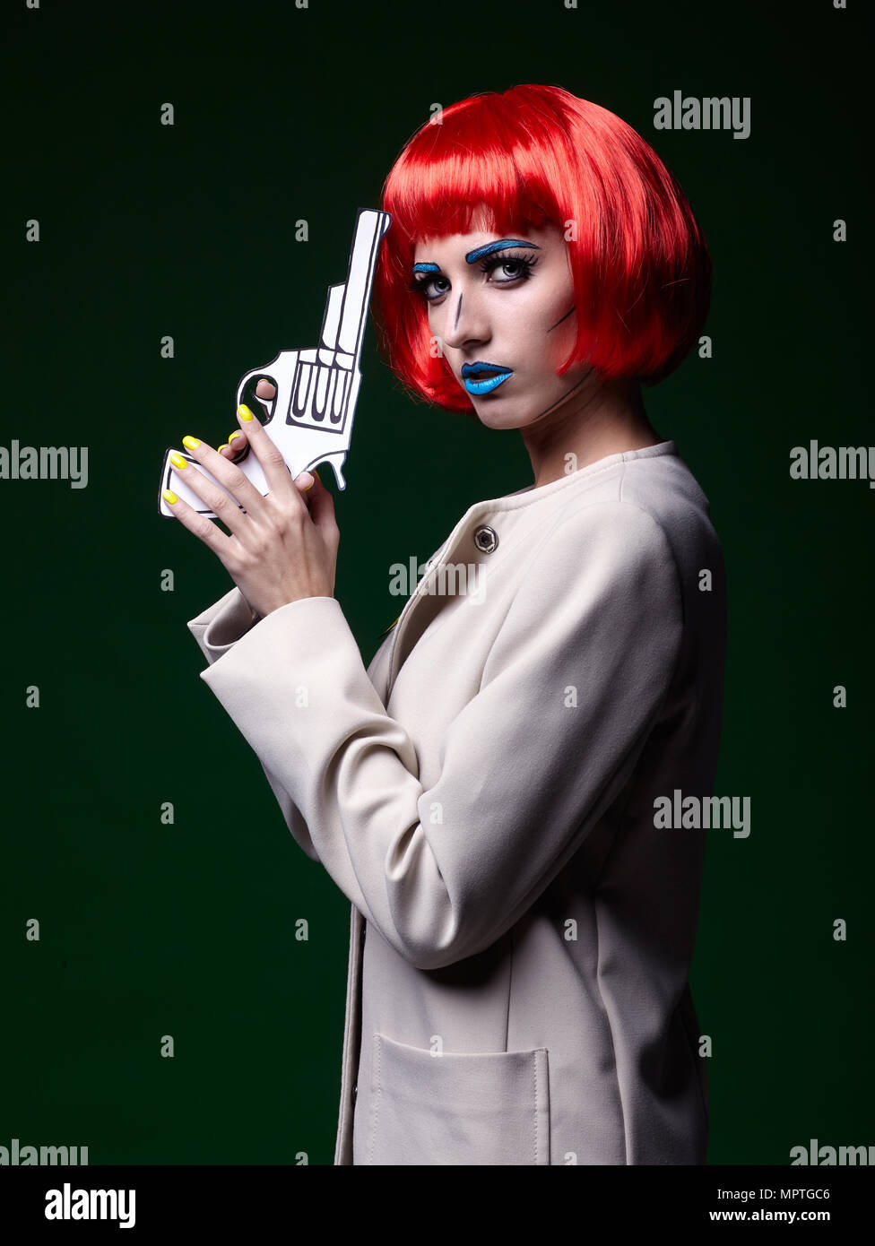 Portrait of young woman in comic pop art make-up style. Female with gun ...