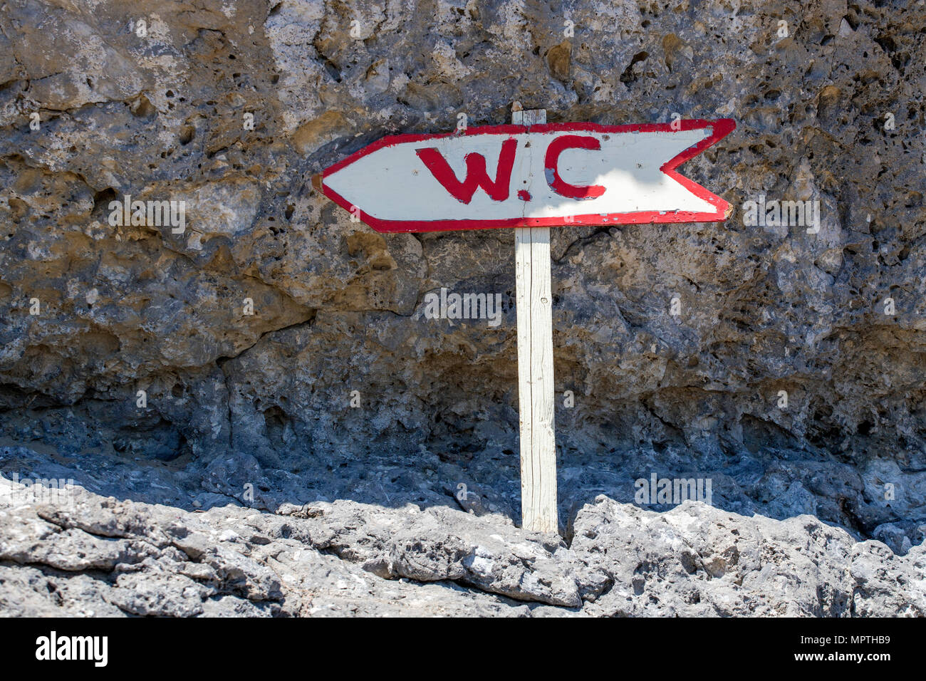 WC sign on the stone at the public sea beach. Beach toilet Stock Photo ...