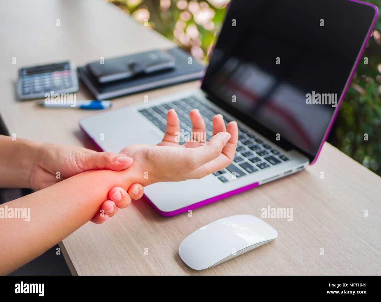 Closeup woman holding her wrist pain from using computer. Office ...