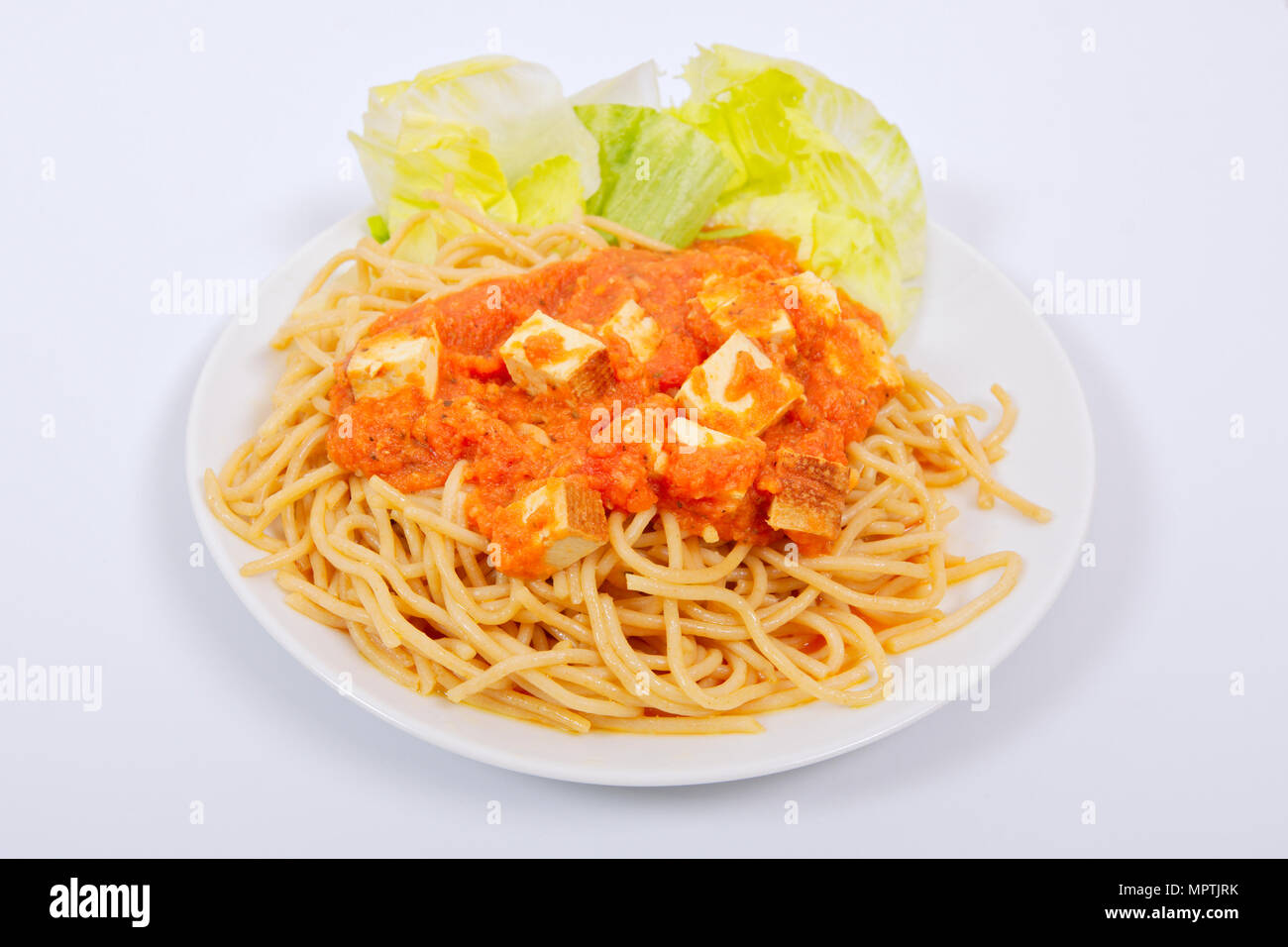 Bolognese spaghetti with tofu on a white background Stock Photo - Alamy