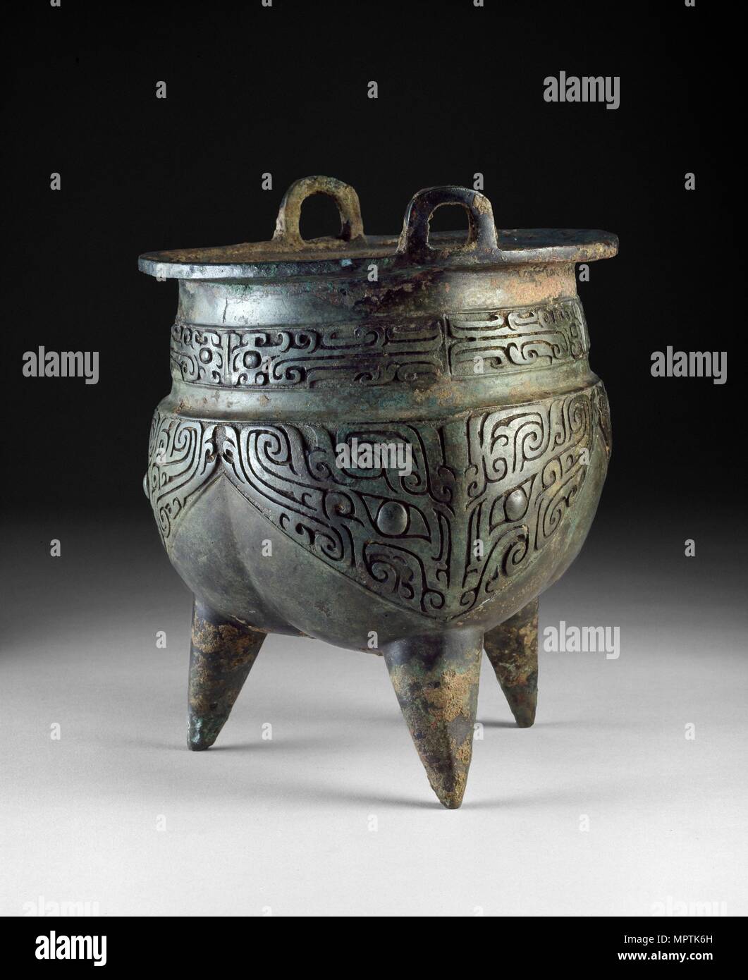 Ritual food vessel, or li ding, with taotie masks, Shang Dynasty ...
