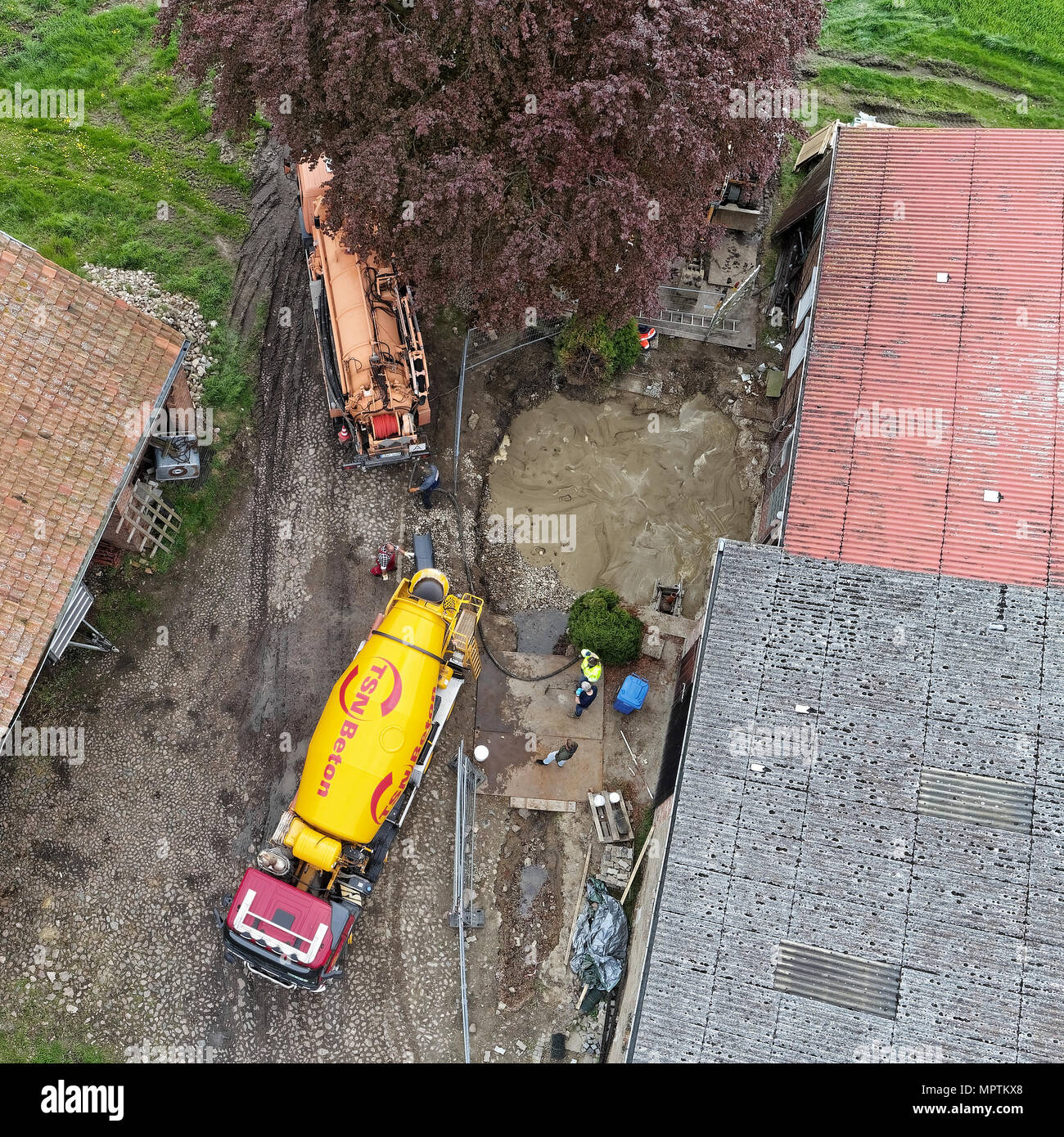 Aerial view of the filling of a construction pit with liquid soil with ...