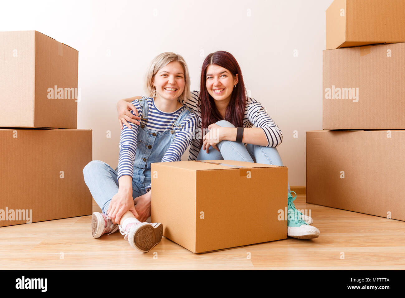 Photo of two women among cardboard boxes Stock Photo - Alamy