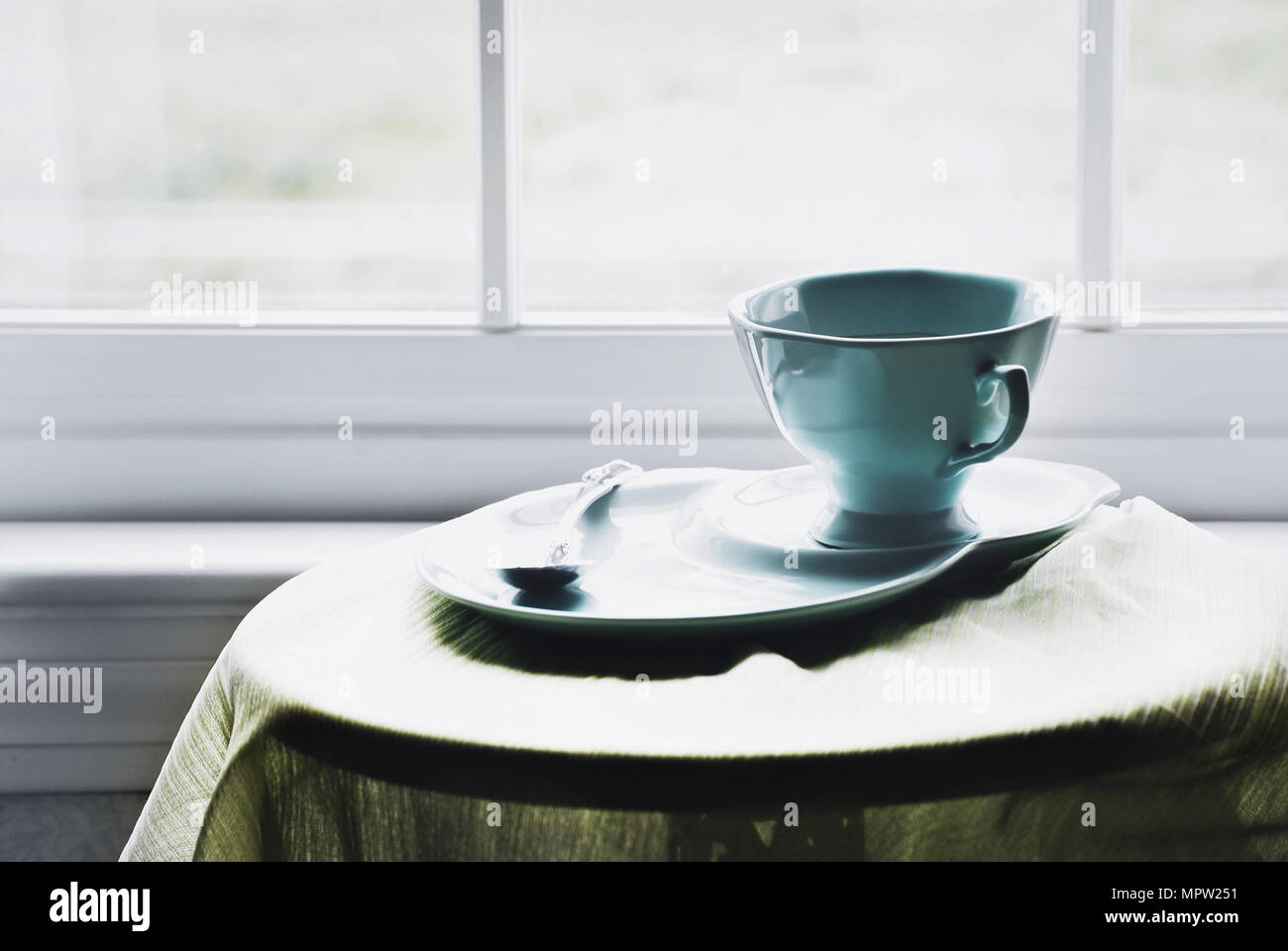 teacup and spoon near window Stock Photo - Alamy