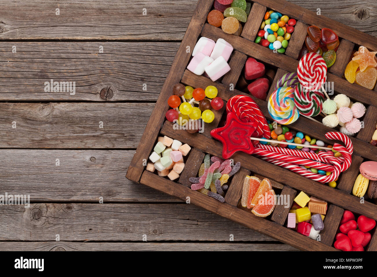 Colorful sweets box. Lollipops, macaroons, marshmallow, marmalade and ...