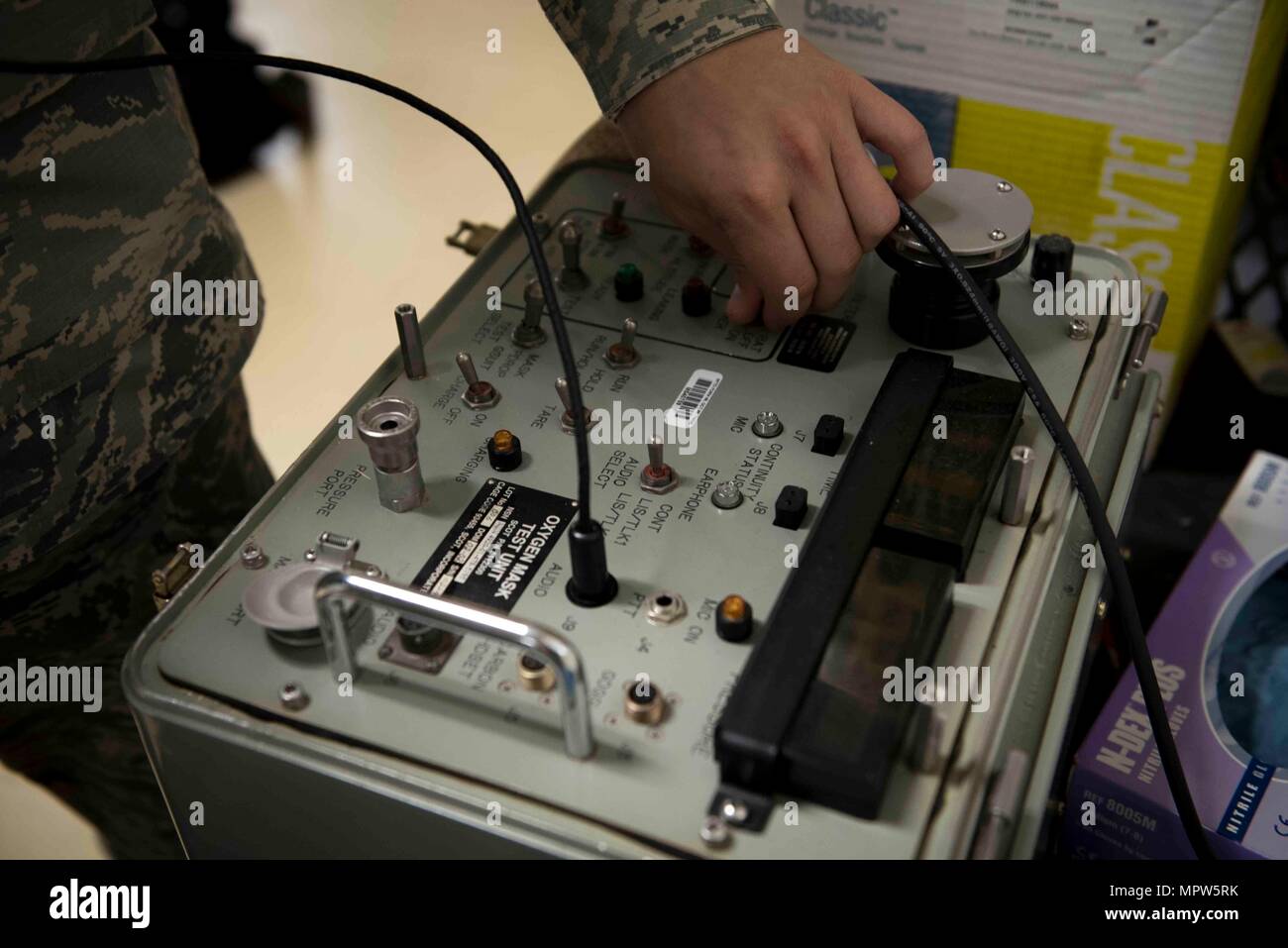 An aircrew flight equipment Airman from the 33rd Rescue Squadron uses a ...