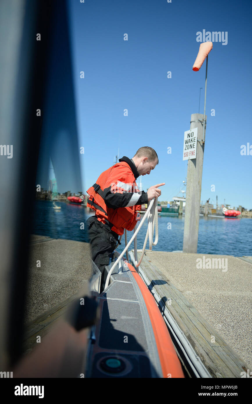 U.S. Coast Guard Petty Officer 3rd Class Ian Burgess tells the coxswain ...