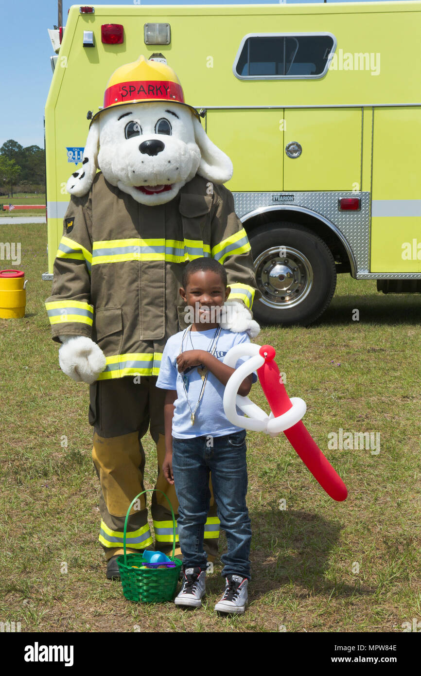 Jayden, a 6-year-old military child, poses with Sparky, the Fort ...