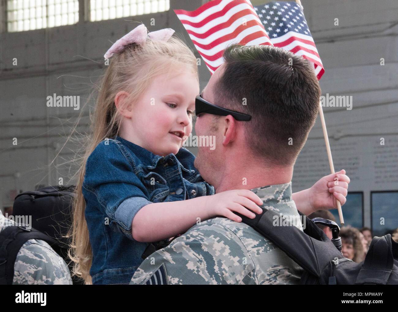 A little girl greets her dad as he returns after a six month deployment ...
