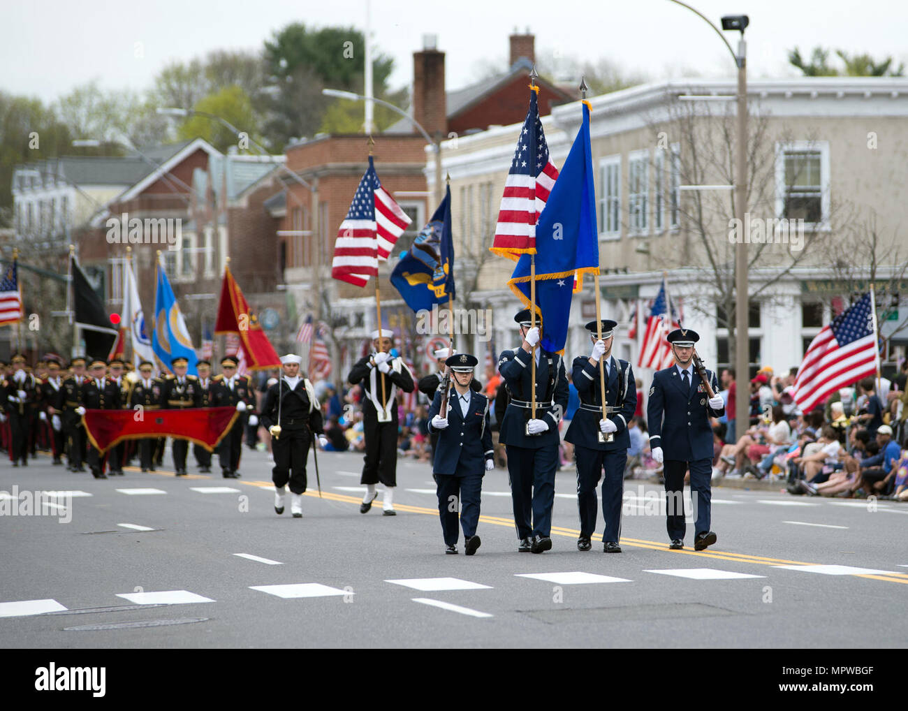 Members of the Patriot Honor Guard participate in a parade during ...