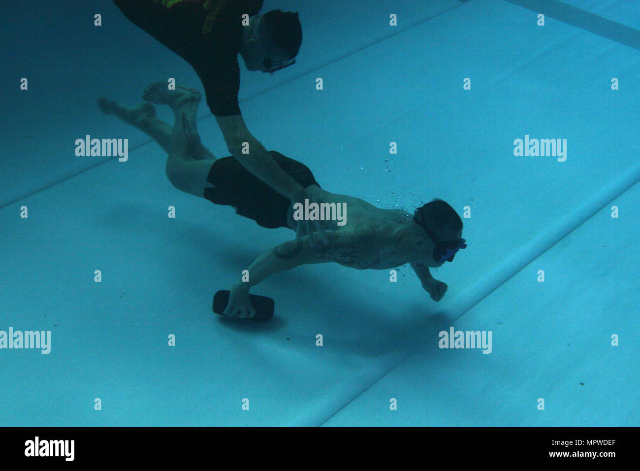 U.S. Marine Corps Sgt. Michael L. Poff, right, Chief Instructor, with ...