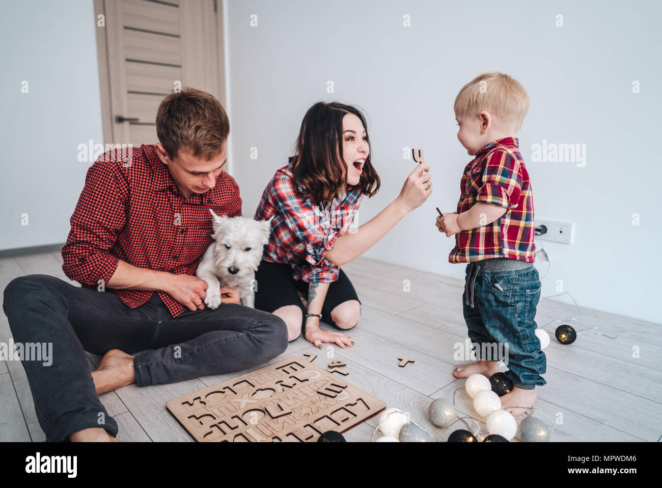 Happy family are playing together on the floor Stock Photo - Alamy