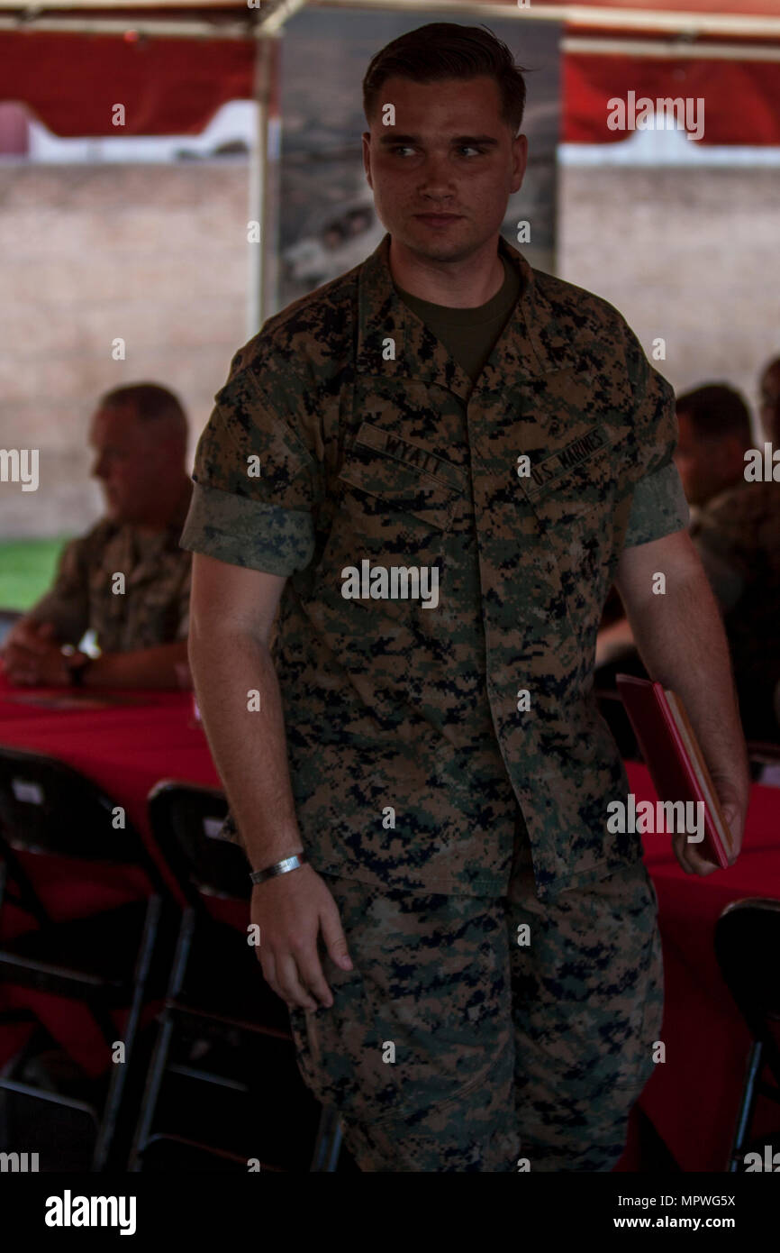 U.S. Marine Corps Cpl. Nathen Wyatt receives an award during a ceremony ...