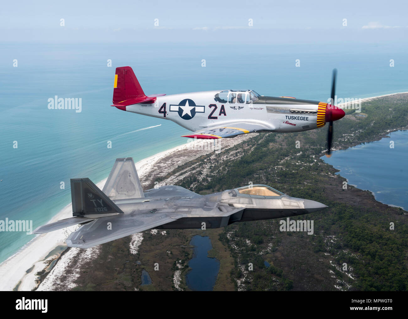 An F-22 Raptor from Tyndall Air Force Base flies alongside a P-51 ...