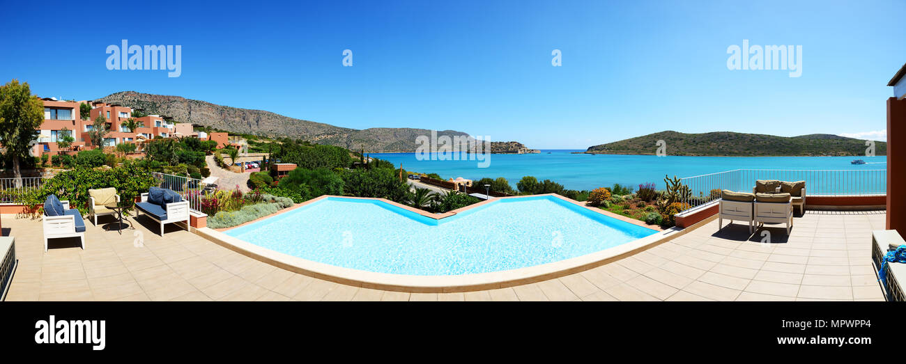 Panorama of swimming pool at luxury hotel with a view on Spinalonga ...