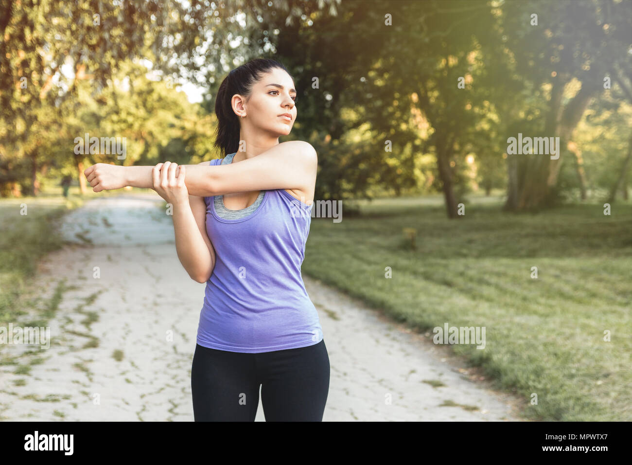 Sporty woman warming up before workout, yoga or fitness outdoor in ...
