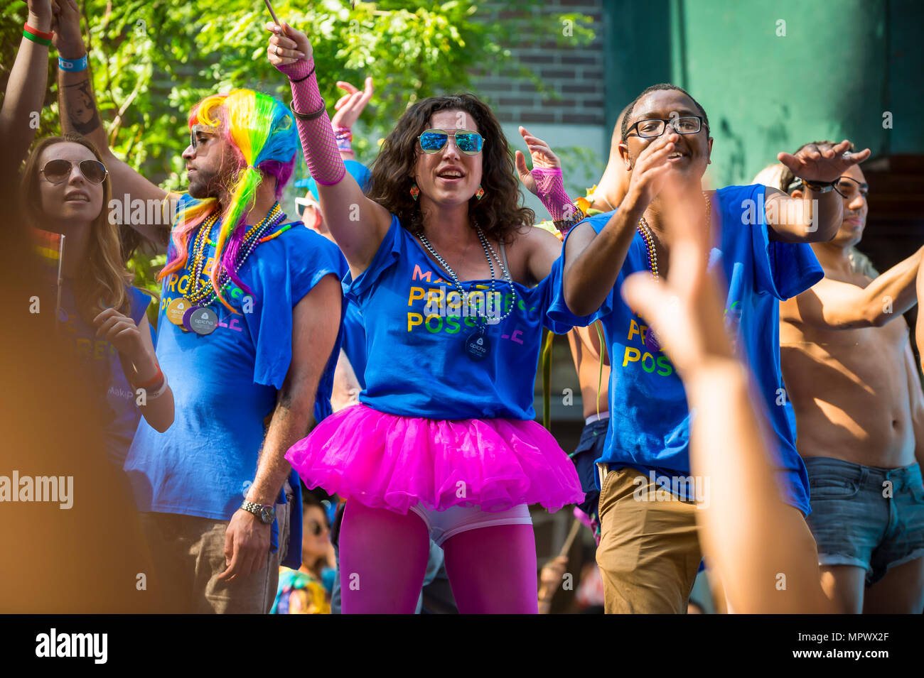 NEW YORK CITY - JUNE 25, 2017: Participants wave rainbow flags on a ...
