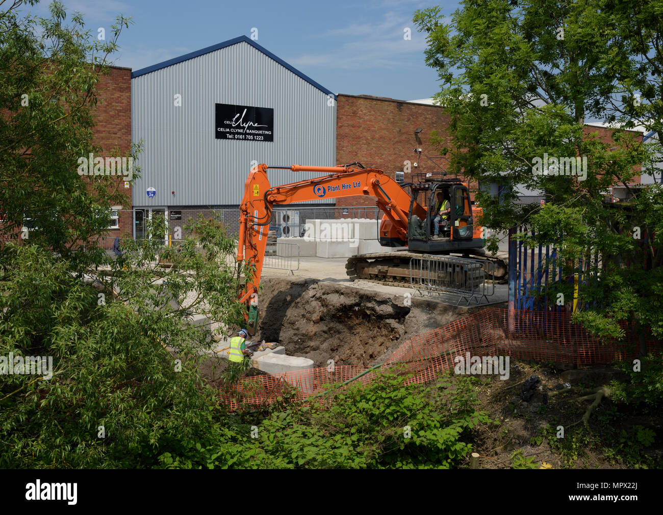 360 tracked hydraulic excavator lifting concrete blocks onto new flood ...