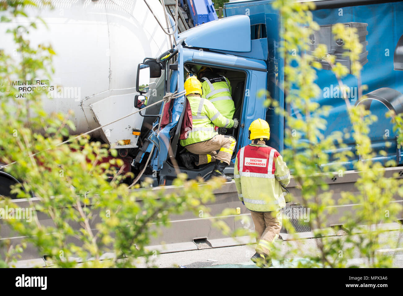 Four HGVs crash one man trapped fire service and ambulance crews trying to extracate him air ...