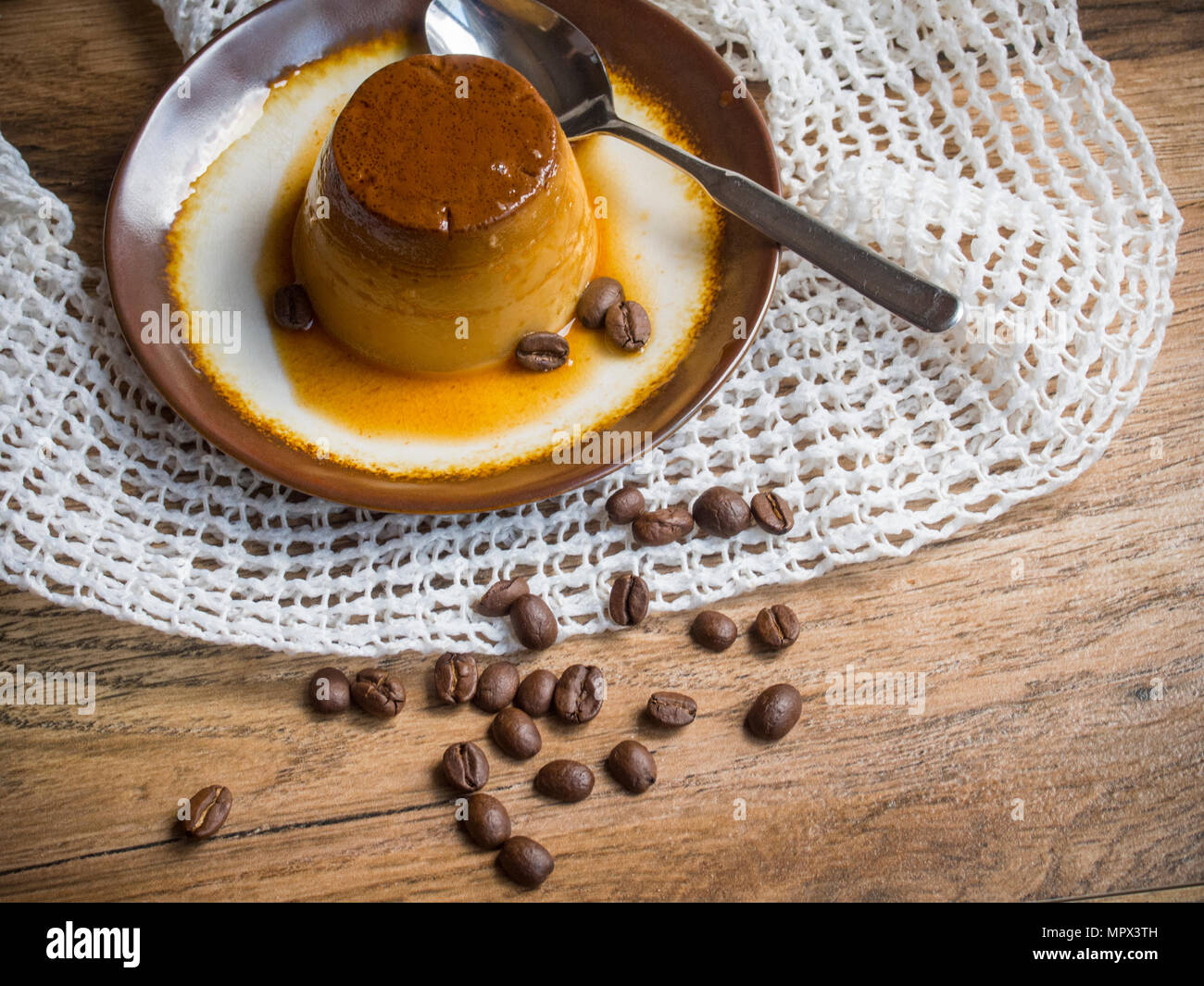 Coffee flan in a plate on wood background Stock Photo - Alamy