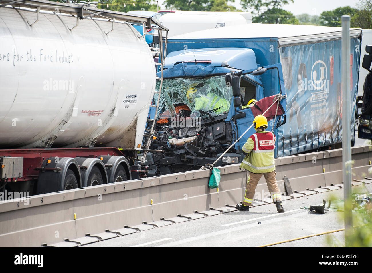 Four HGVs crash one man trapped fire service and ambulance crews trying to extracate him air ...