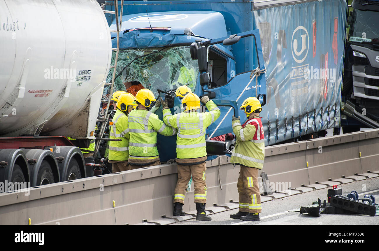 Four HGVs crash one man trapped fire service and ambulance crews trying to extracate him air ...