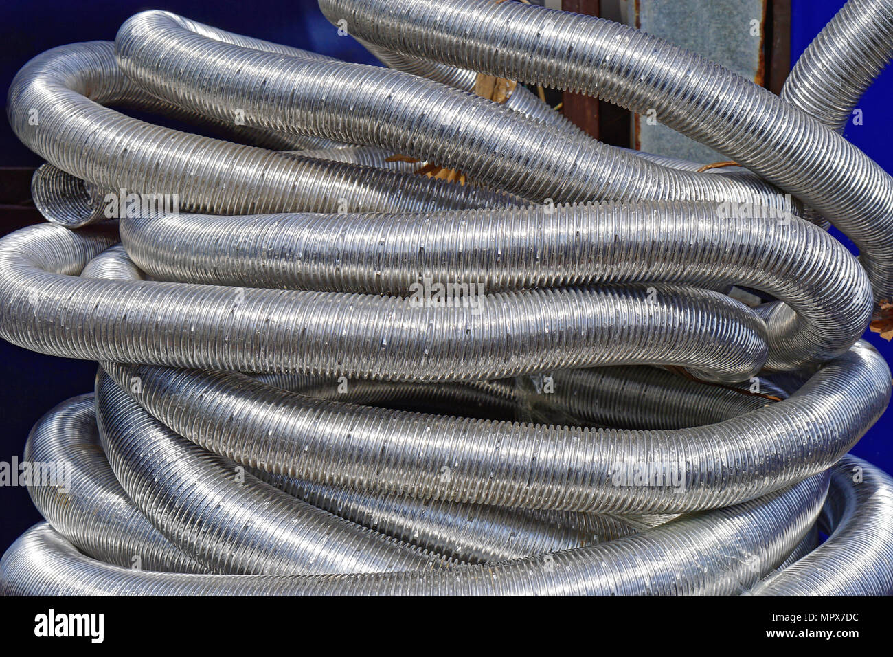 Big bunch of flexible aluminium hoses and pipes Stock Photo - Alamy