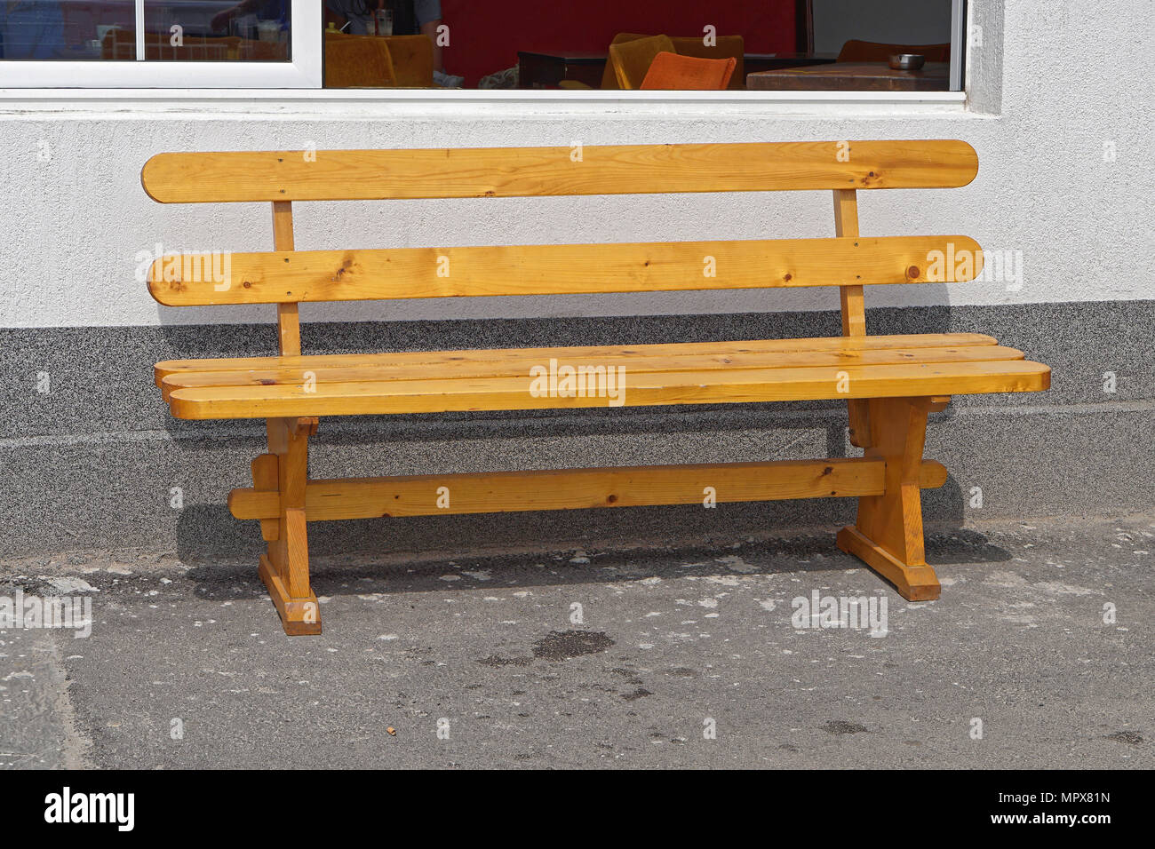 New wooden bench in front of house day Stock Photo - Alamy