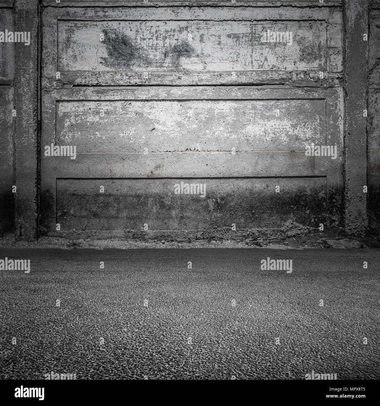 Grungy gray concrete wall and asphalt ground, abstract empty interior ...