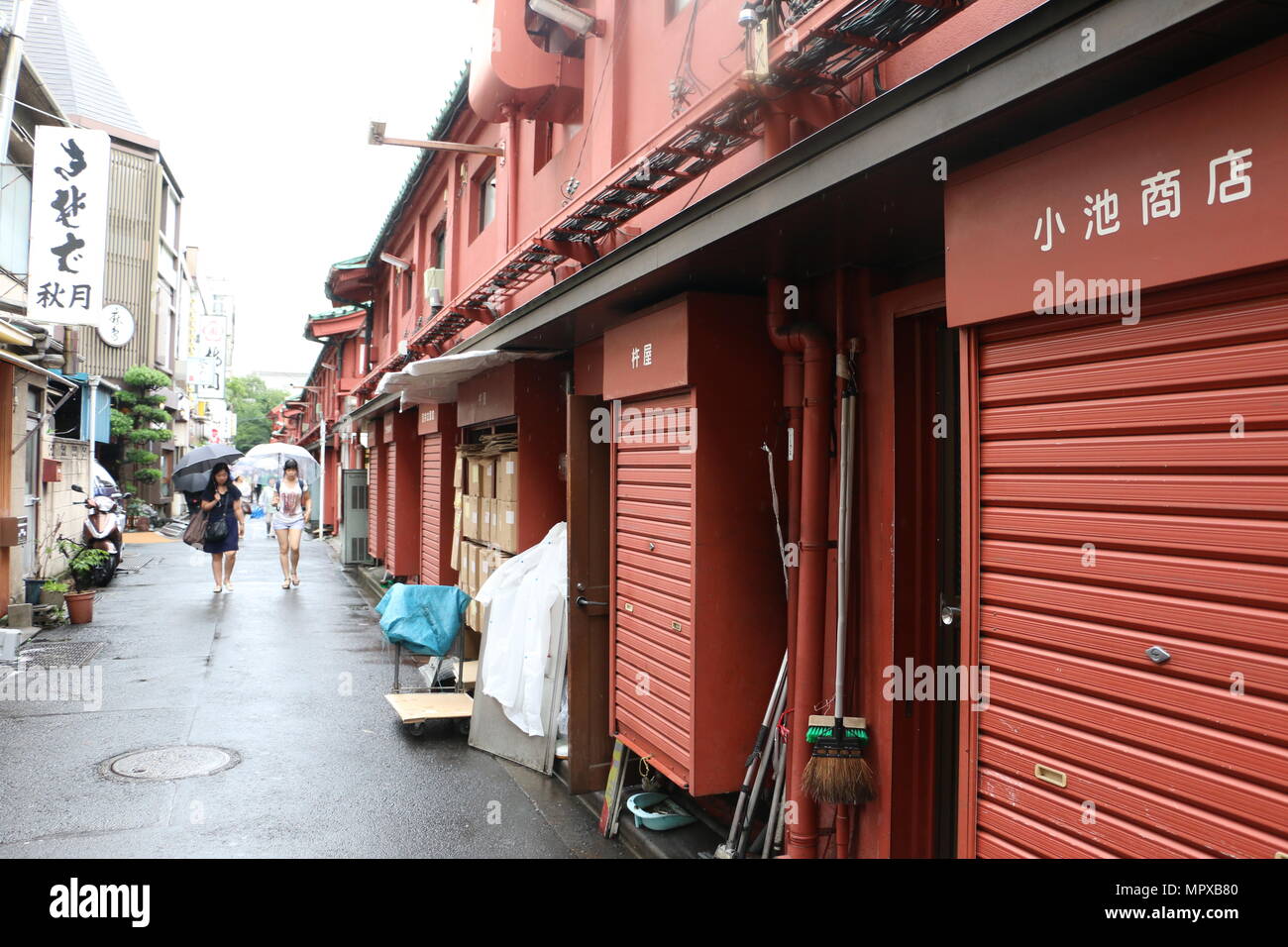Two Japanese women walking in a backstreet of Asakusa parallel to the ...