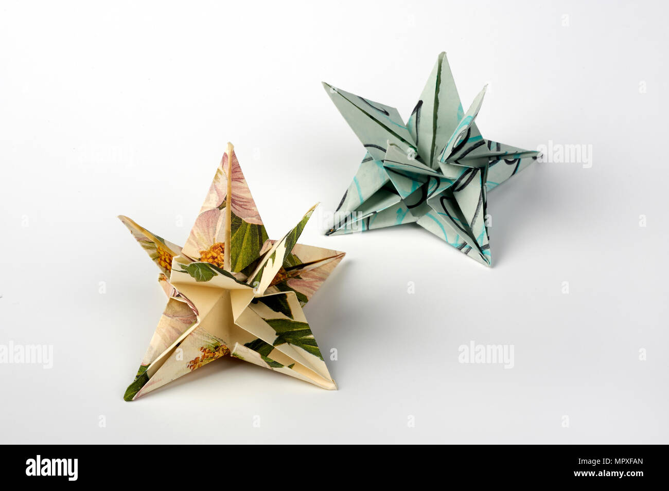 two paper origami on white background Stock Photo - Alamy