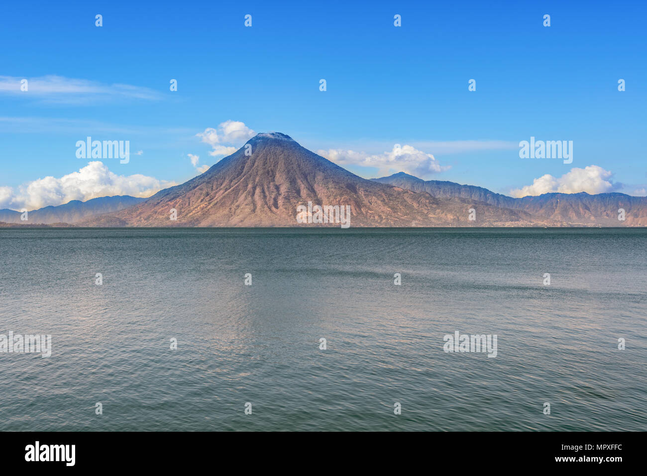 Picturesque landscape view of a volcano on the far side of Lake Atitlan ...