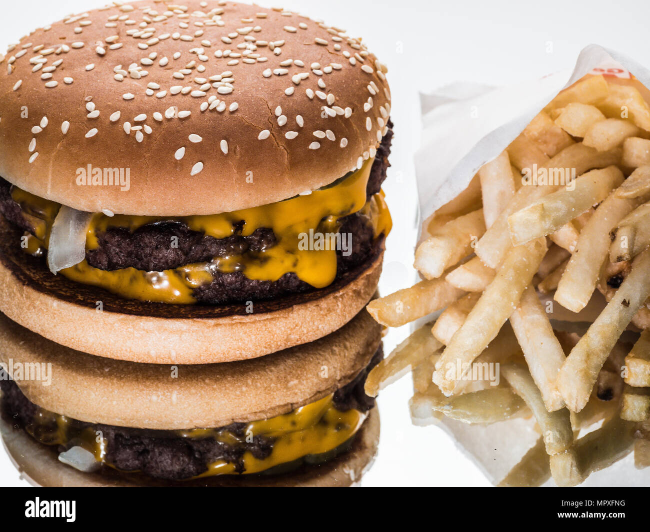 double pattie hamburger and french fries on mirror Stock Photo - Alamy