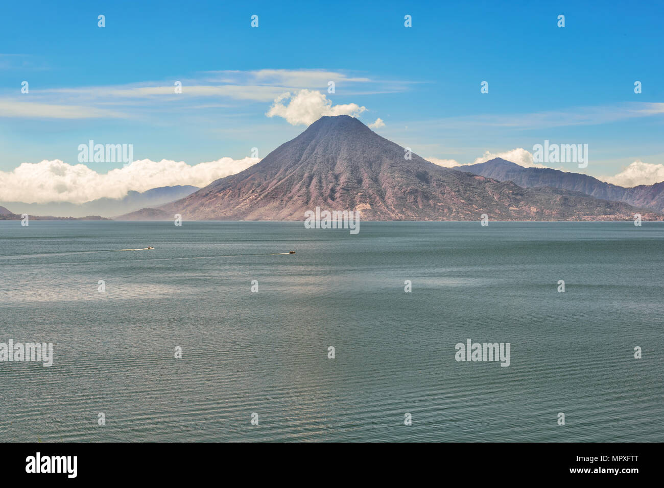Picturesque landscape view of a volcano on the far side of Lake Atitlan ...