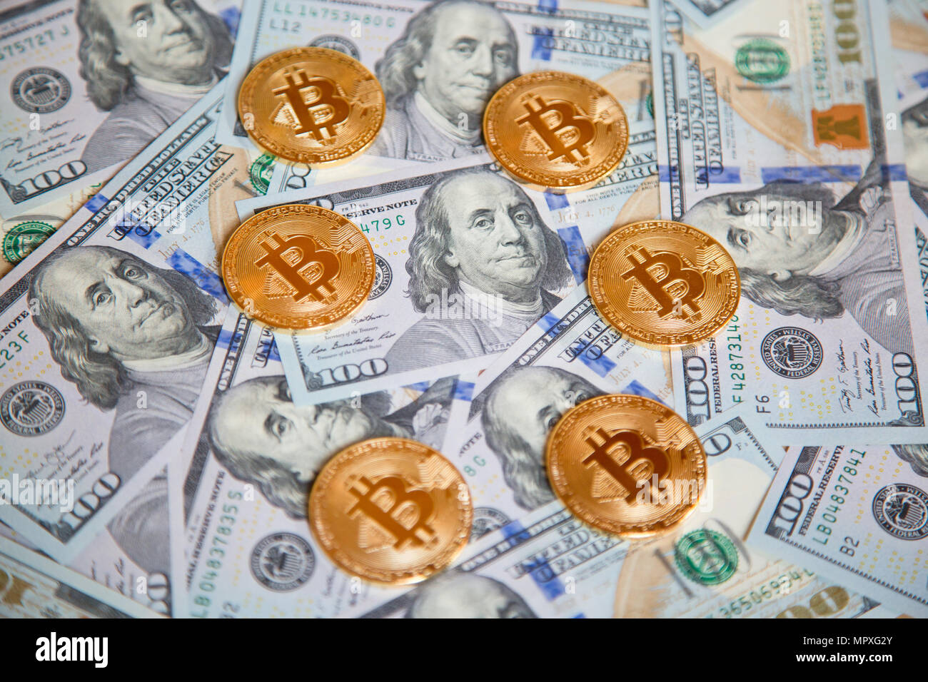 Bitcoins on the US dollar background Stock Photo - Alamy