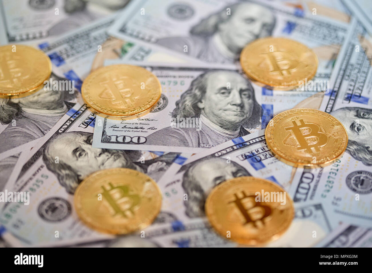 Bitcoins on the US dollar background Stock Photo - Alamy