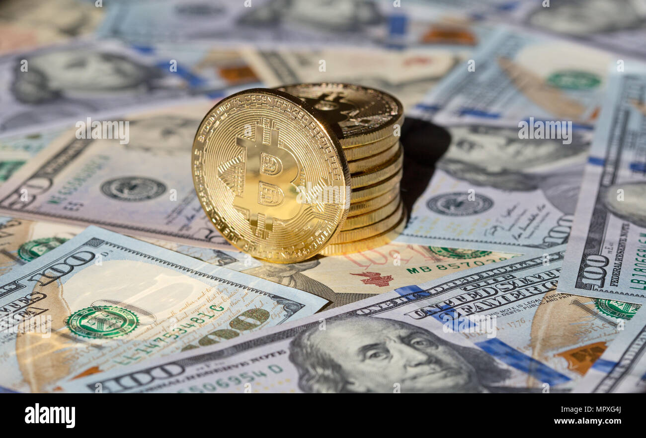 Bitcoins on the US dollar background Stock Photo - Alamy