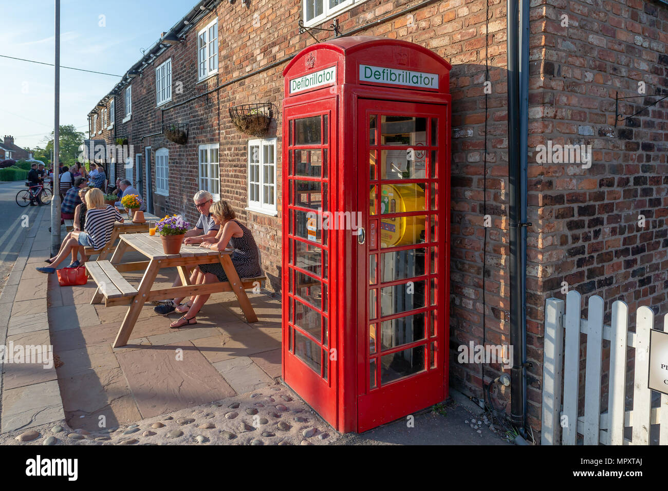 Red K2 telephone box used as a library and defibrillator station ...
