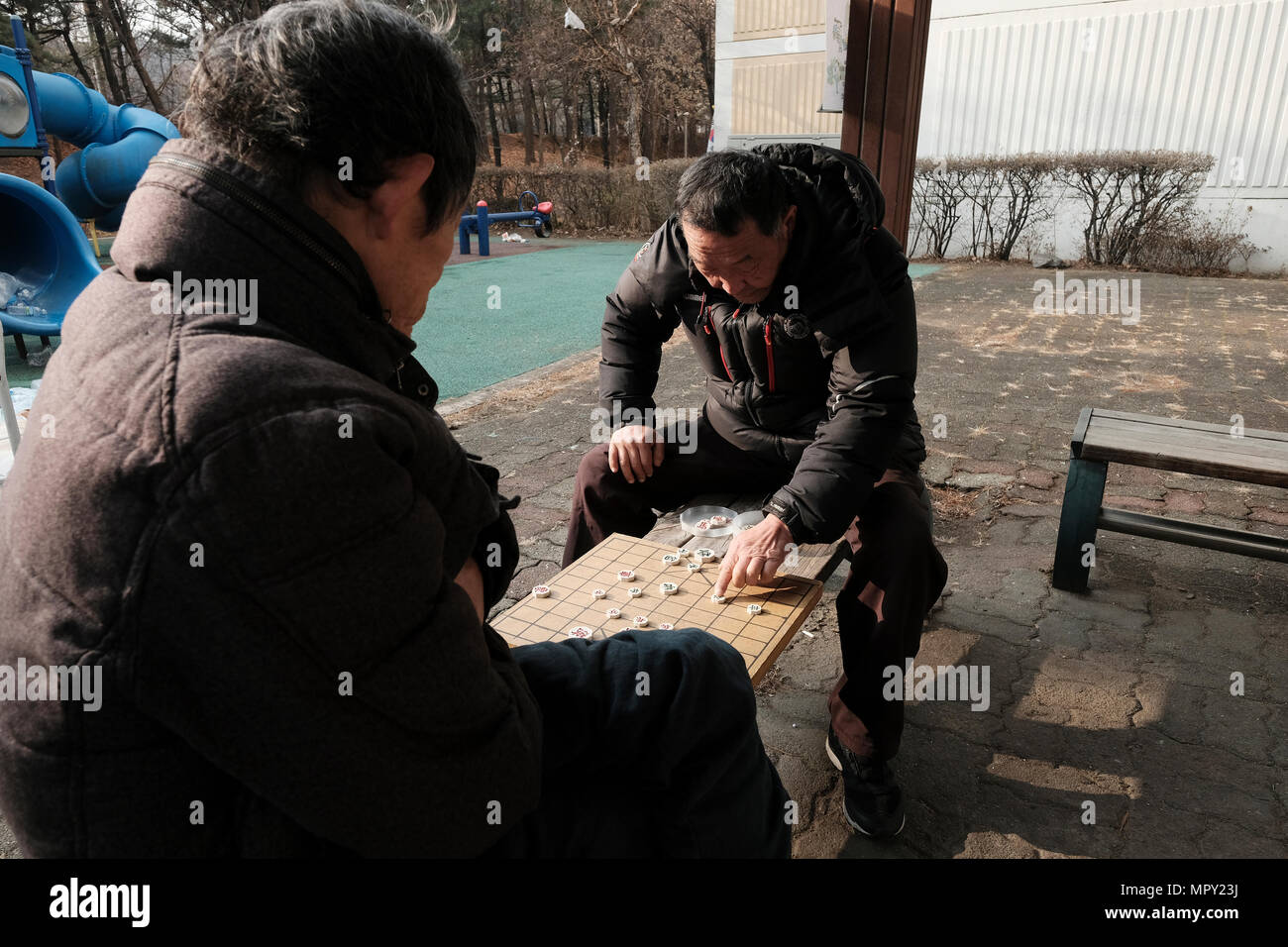 Korean men playing a strategy board game called Janggi changgi or ...