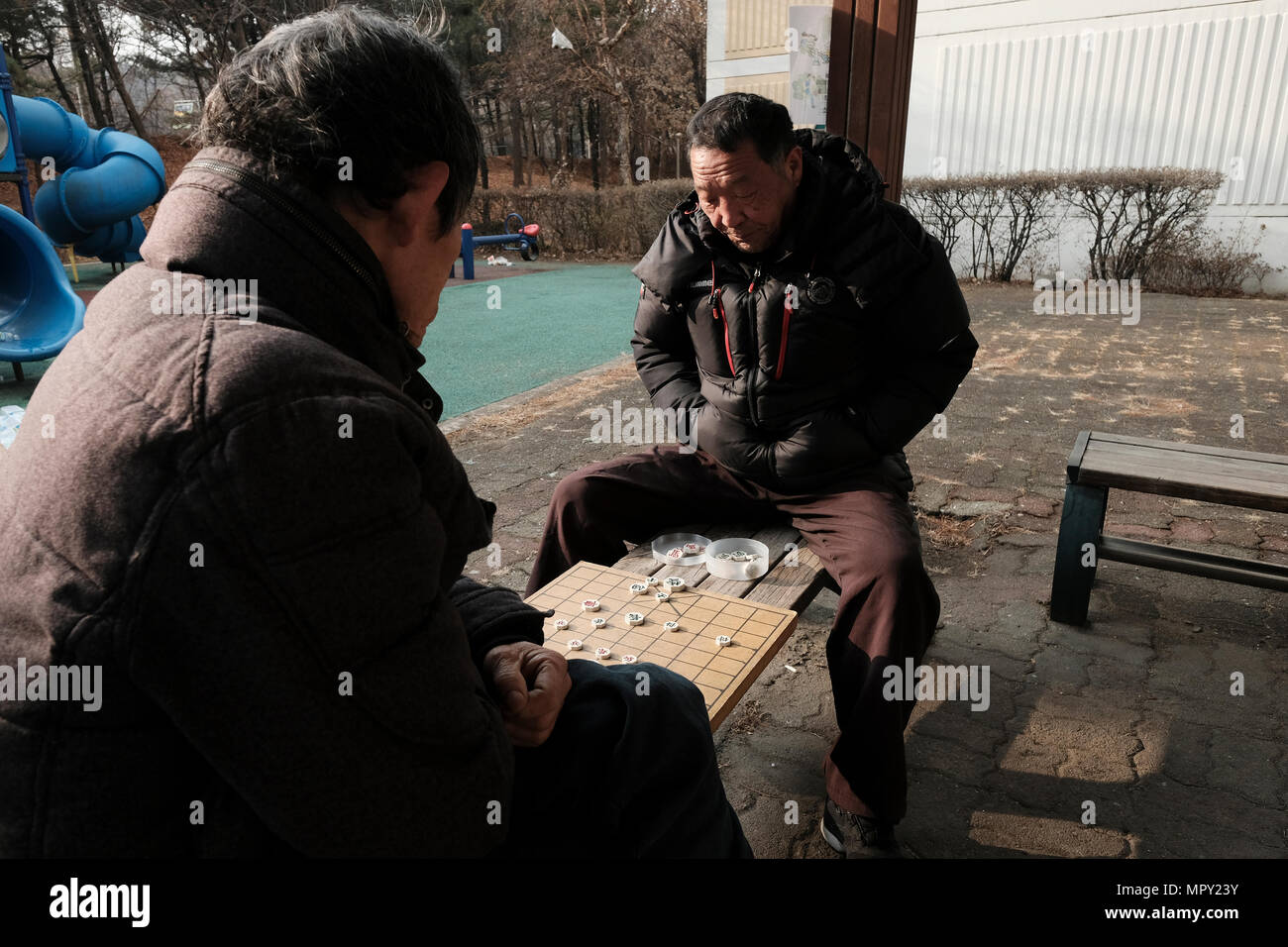 Korean men playing a strategy board game called Janggi changgi or ...