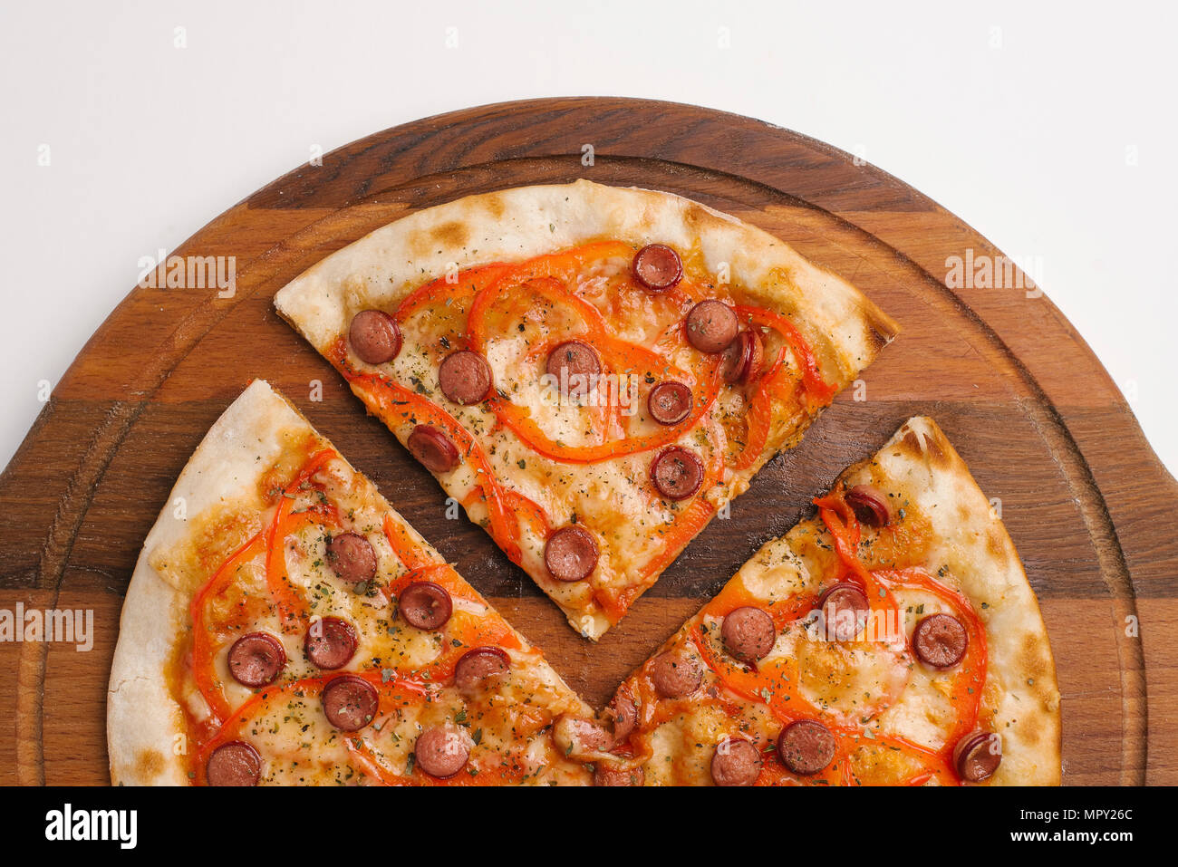 Overhead view of pizza on serving board over white background Stock ...