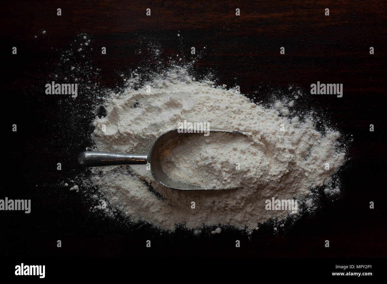 Overhead view of cooking utensil on flour at table Stock Photo - Alamy