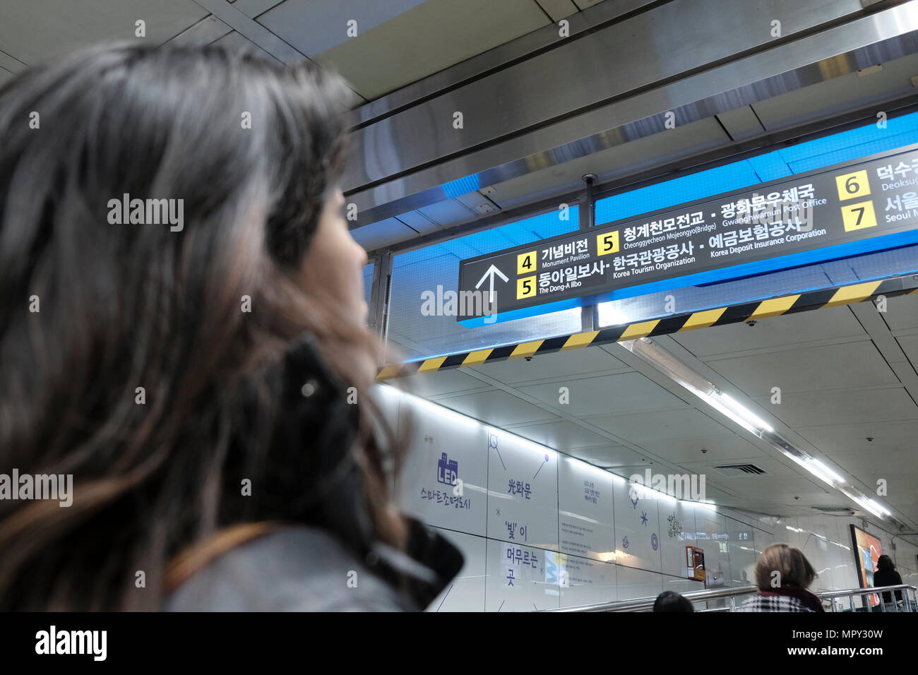 Commuter looking at information signs in Gwanghwamun Station of the ...
