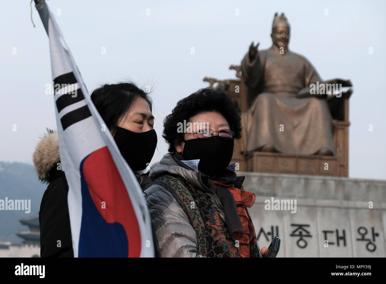 Two Korean woman holding the South Korean flag standing next to the ...
