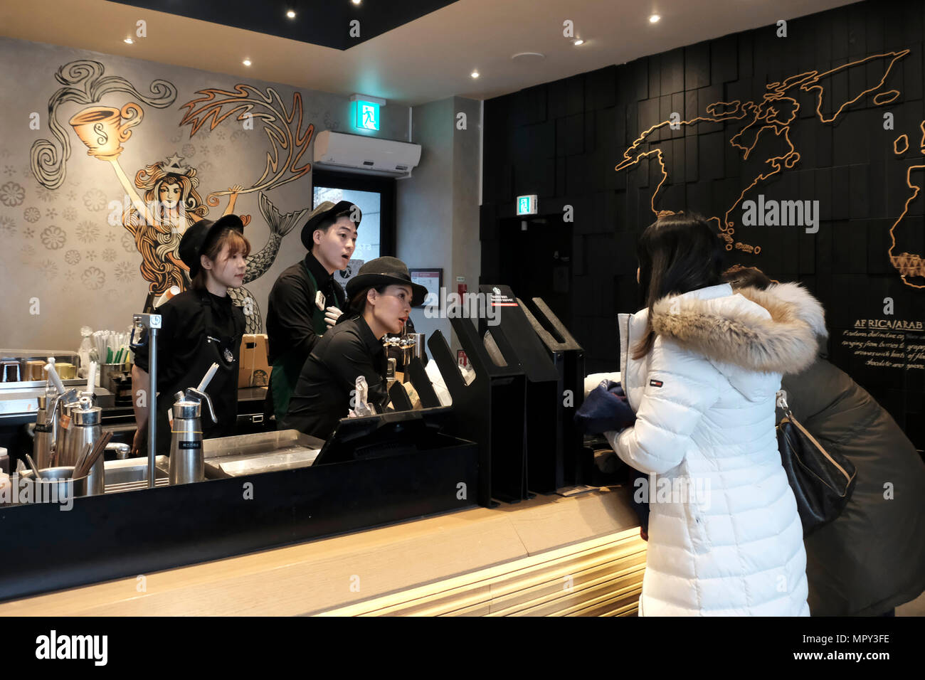 Young Korean women buying coffee in Starbucks cafe in the city of Seoul ...